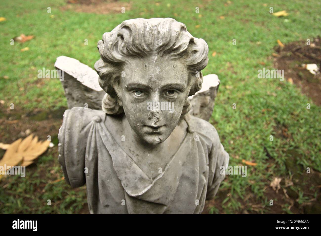 A broken statue of an angel figure at Taman Prasati museum (museum of ...