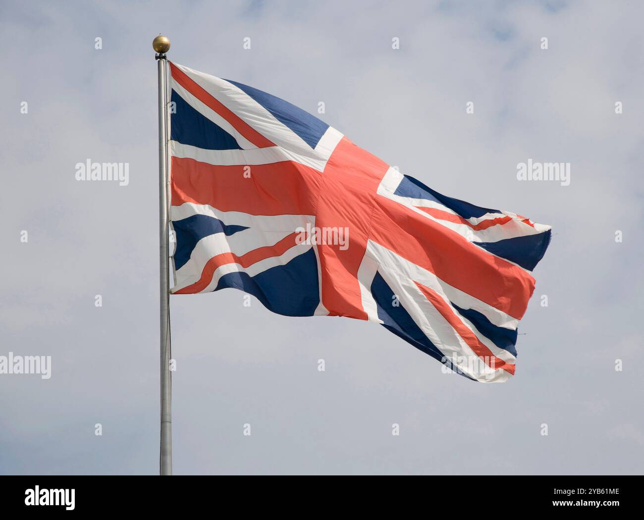 UK Union flag, Union Jack flying from a flag pole Stock Photo - Alamy