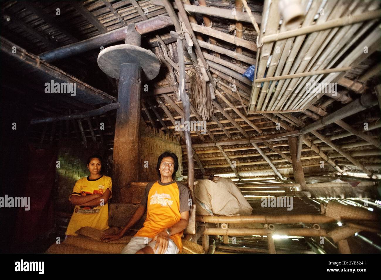 Portrait of Umbu Tiu, a villager, together with his wife inside their ...