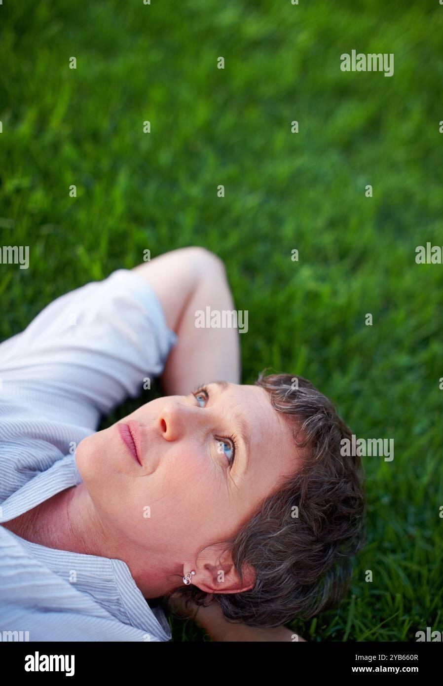 Woman, thinking and relax on grass space for comfort, peace and ...