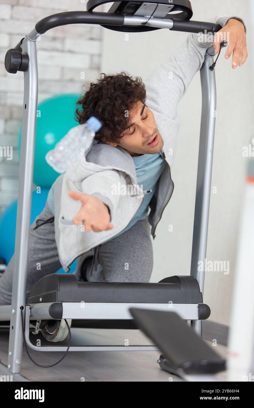 man falling on a treadmill while during gym Stock Photo - Alamy