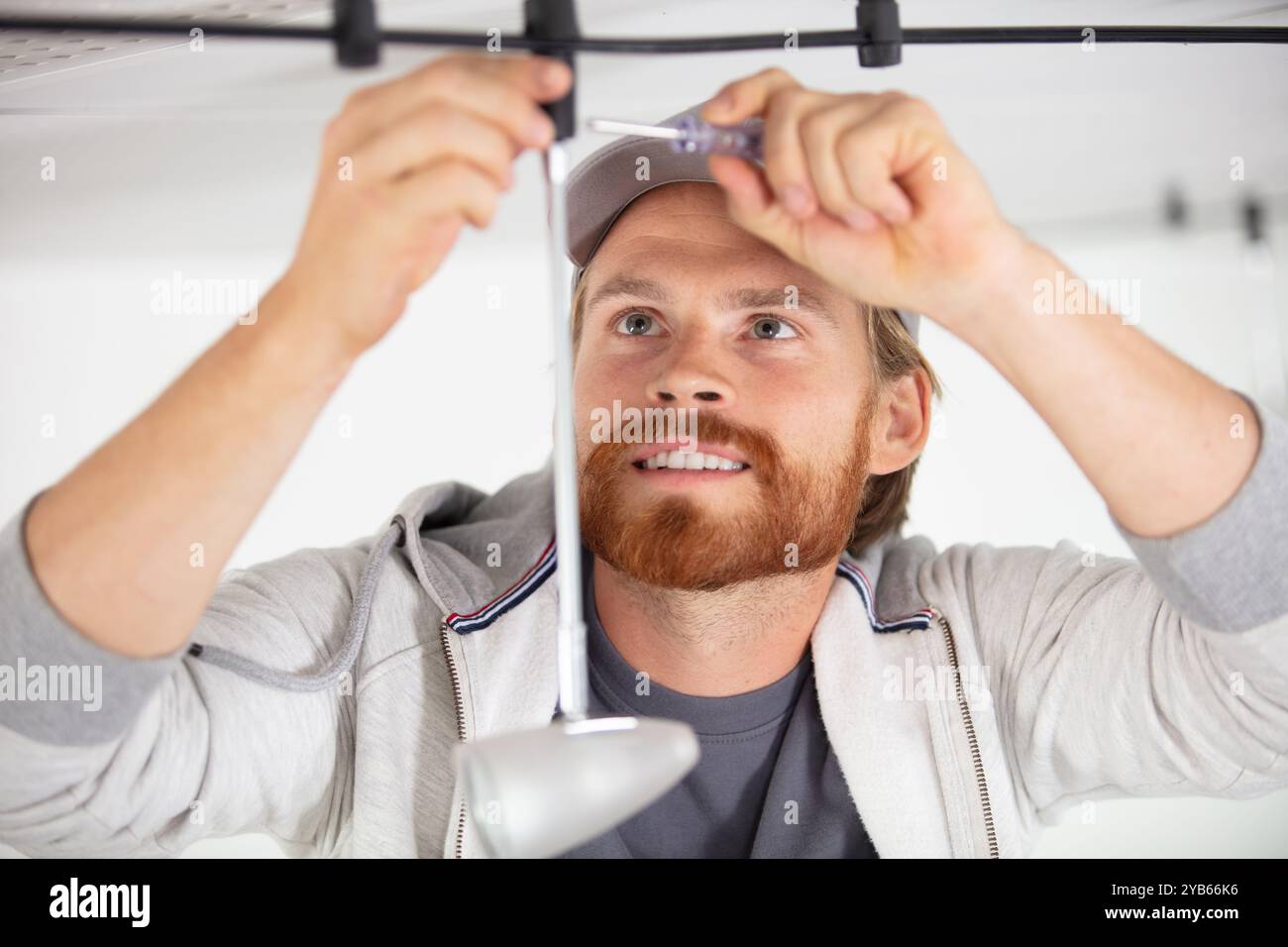 Young builder installing electrical hi-res stock photography and images ...