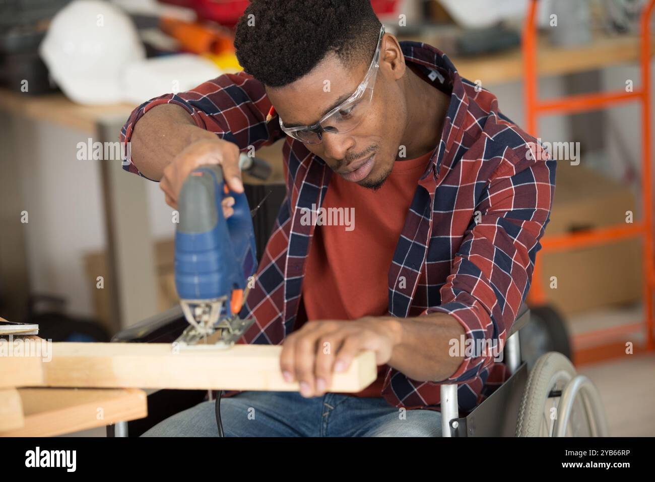 disabled man using jigsaw tool Stock Photo - Alamy