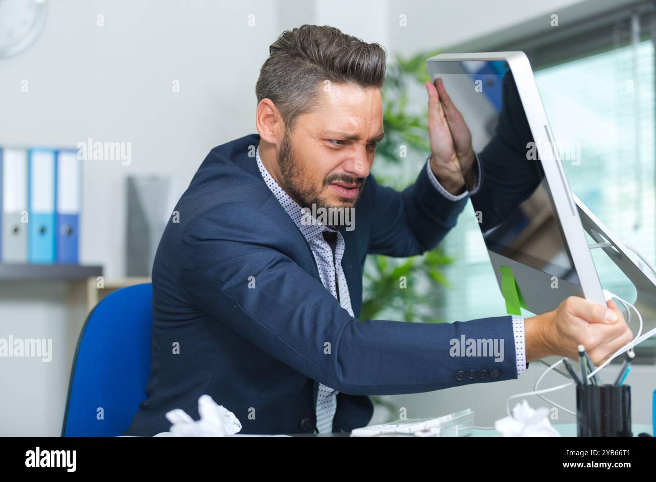 angry man hitting the computer screen Stock Photo - Alamy