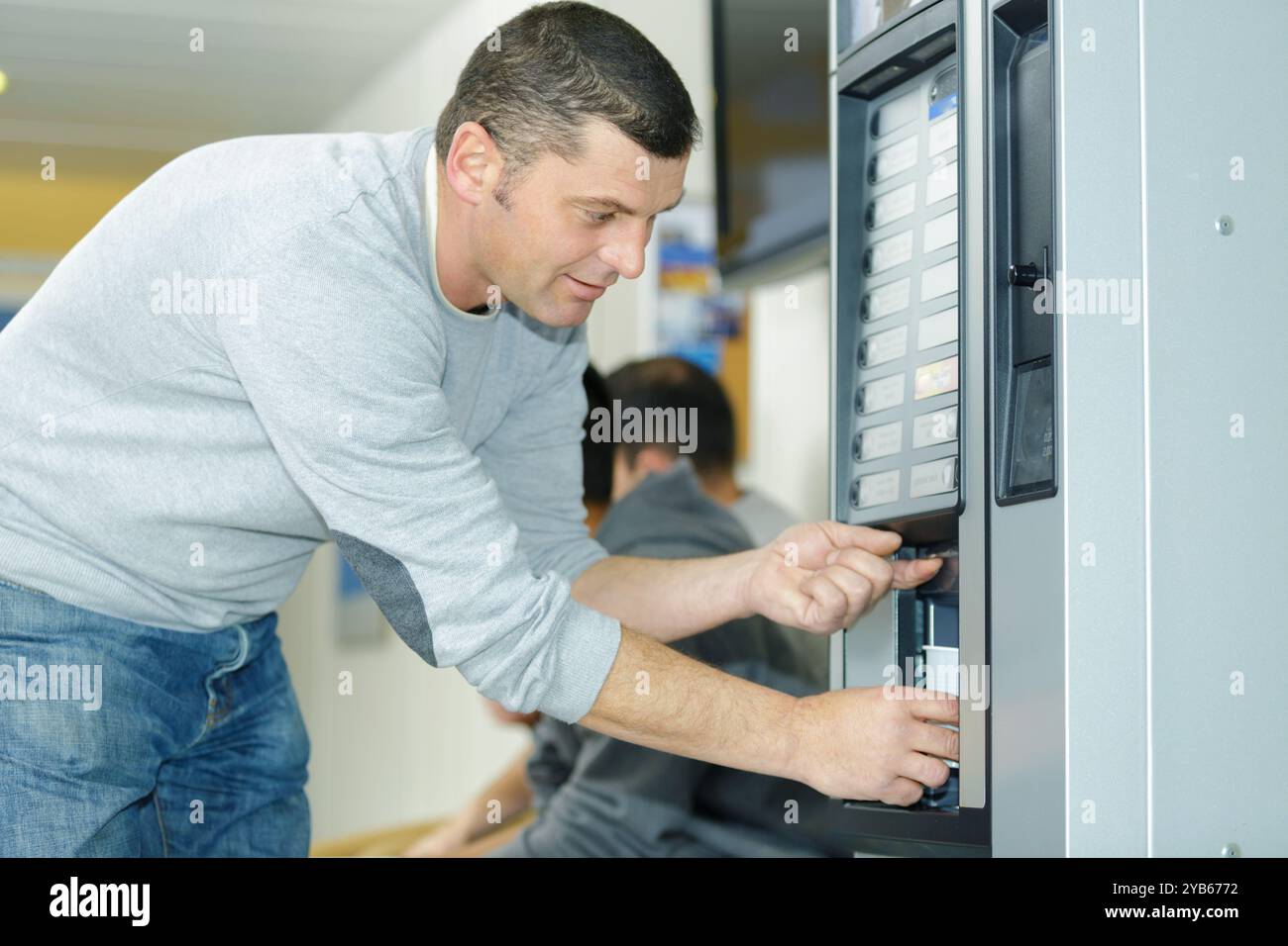 man in coffee vending machine Stock Photo - Alamy