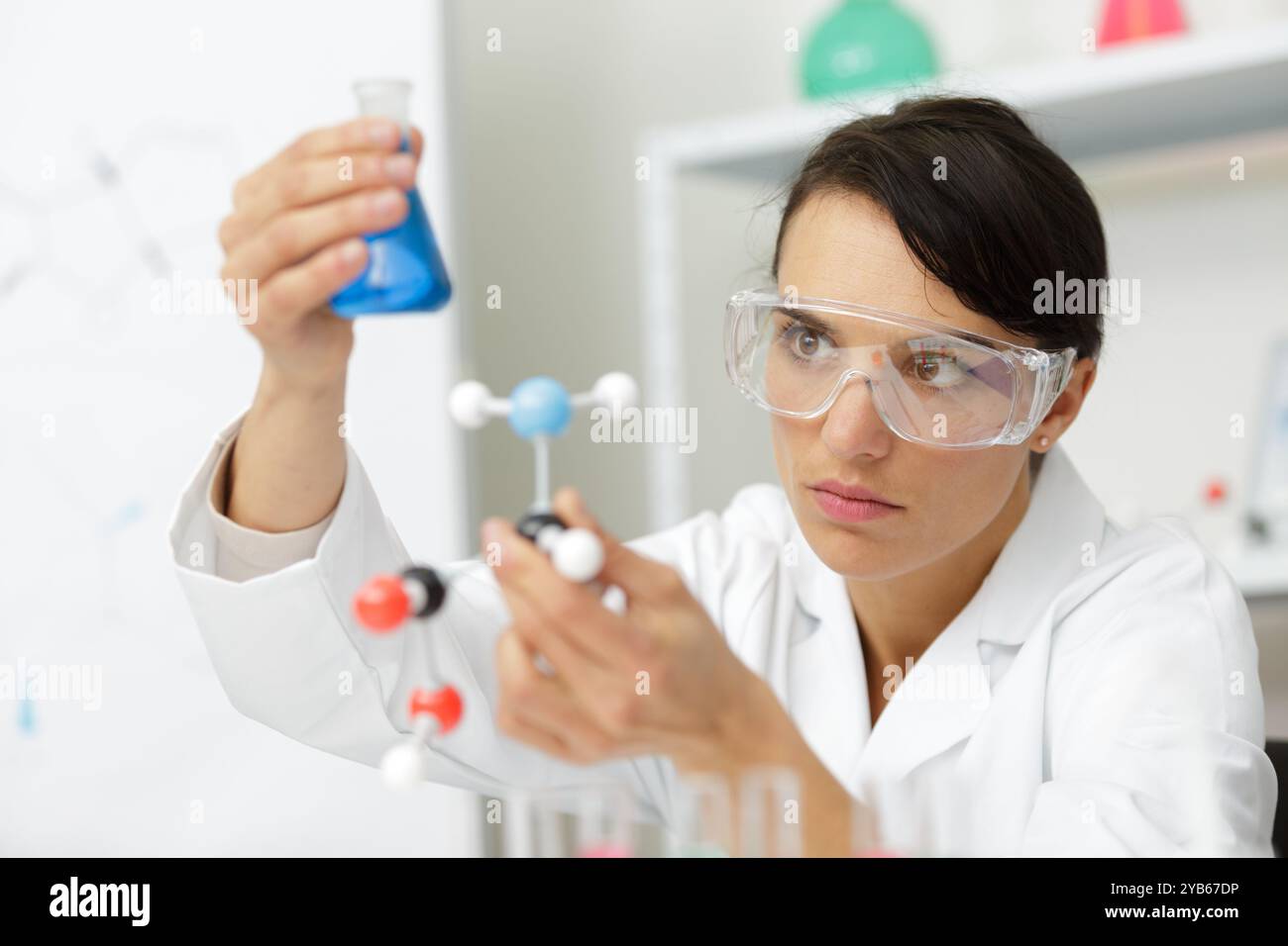 working with flasks in lab Stock Photo - Alamy