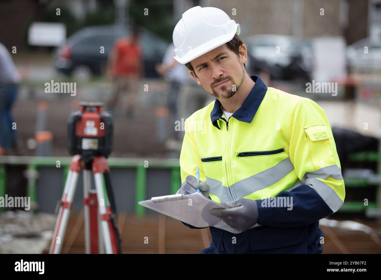 architect with laser measuring tool on building site Stock Photo - Alamy