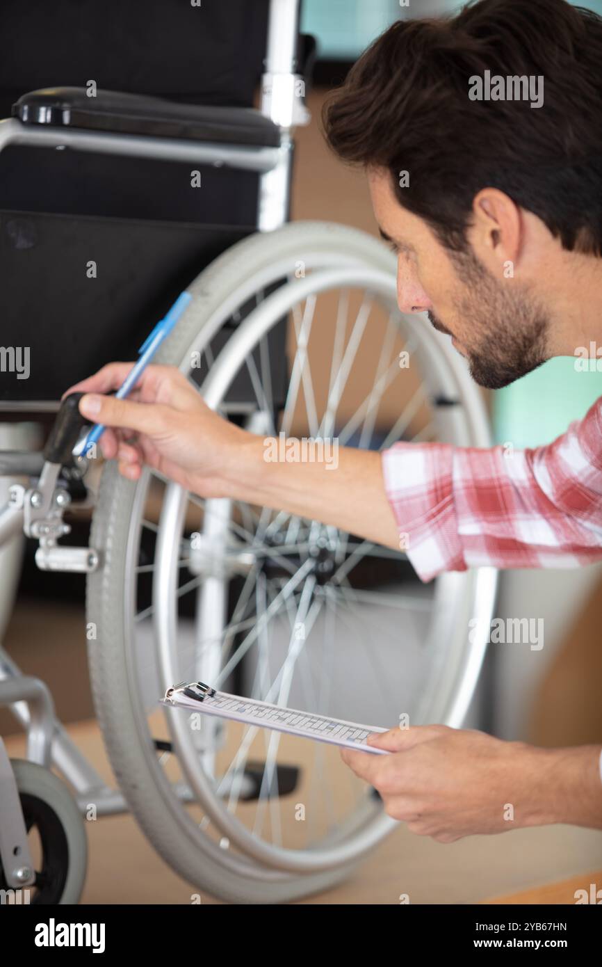 young man fixing a wheelchair Stock Photo - Alamy