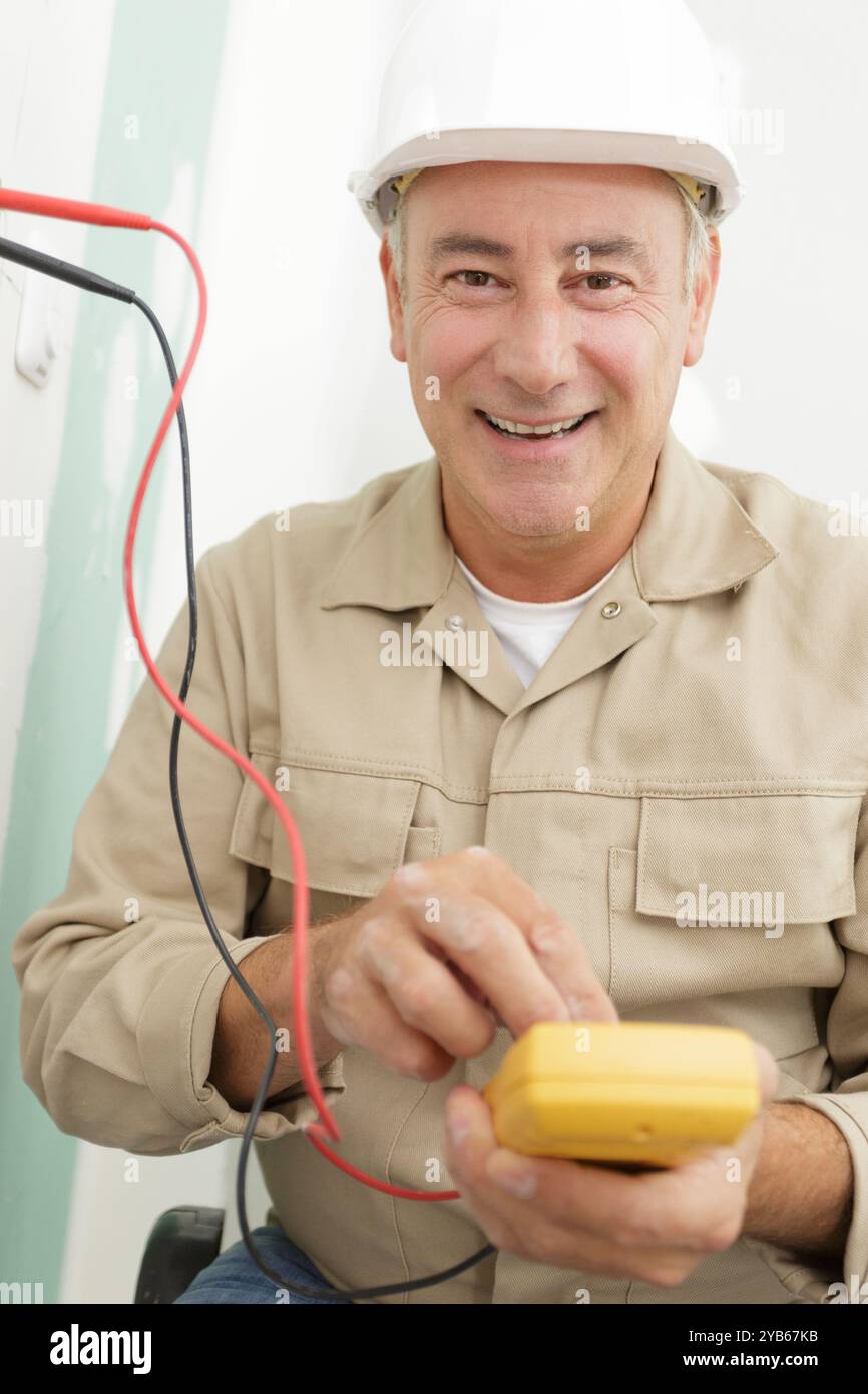 electrician technician at work measures the voltage Stock Photo - Alamy