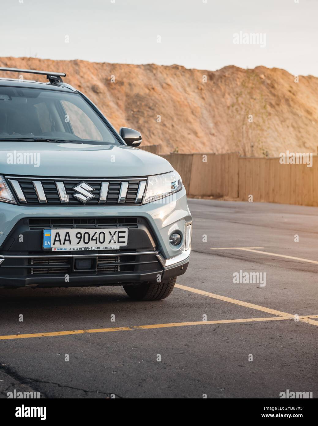 Suzuki Vitara in parking lot - close up view. Front end view of compact ...