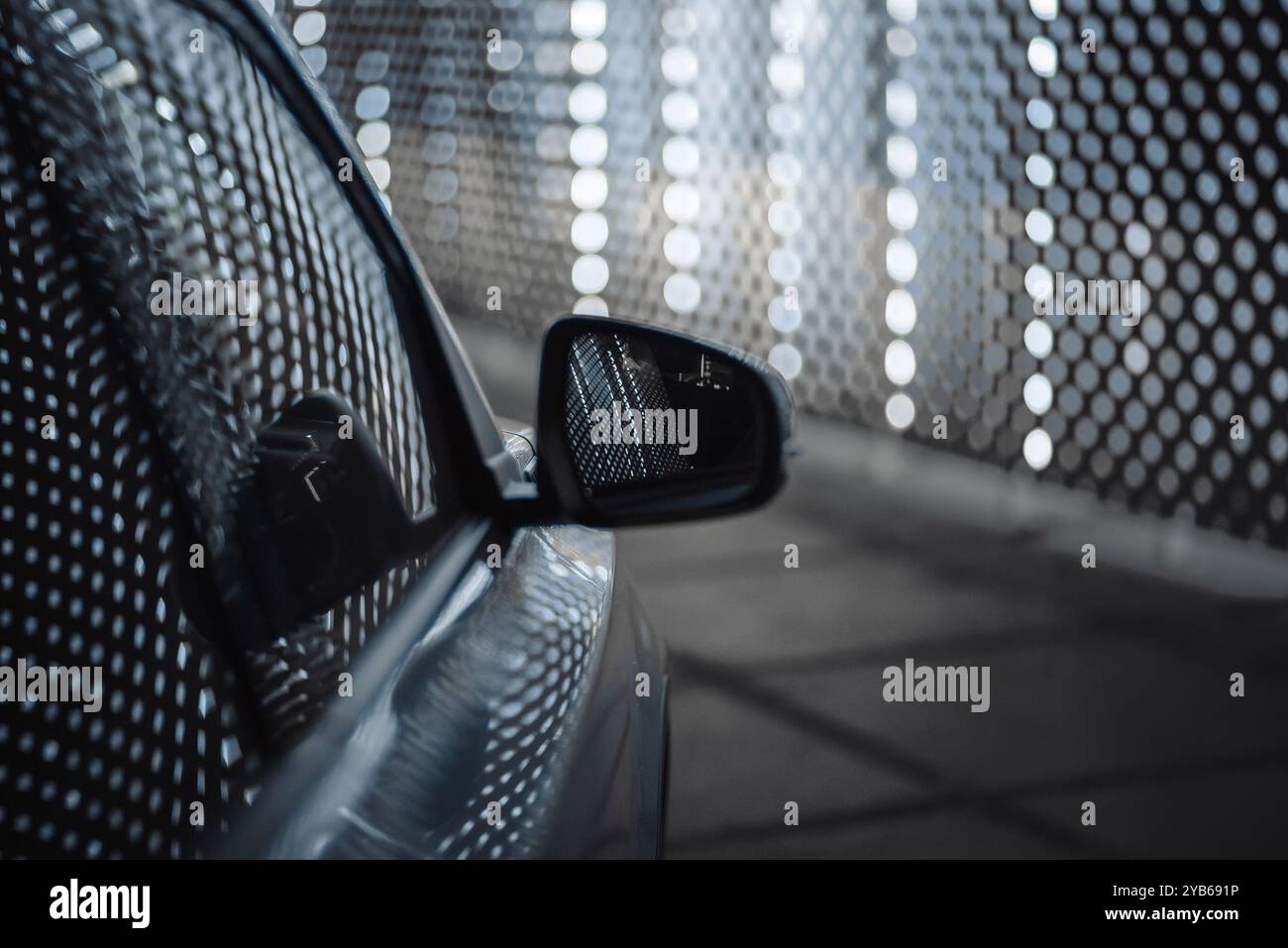 Car side mirror - close up image. Night city street in the background ...