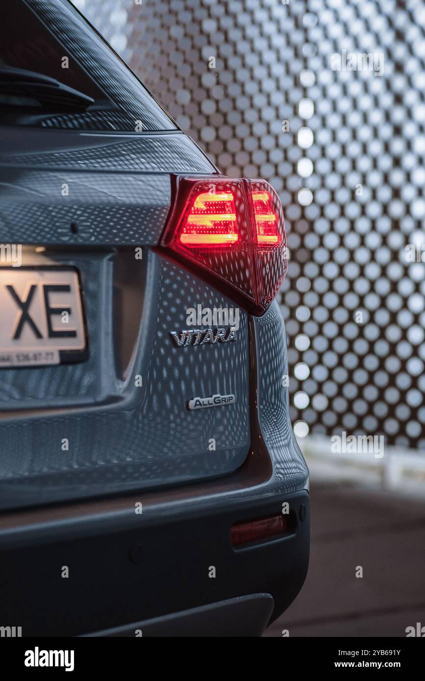 Rear right corner of Suzuki Vitara at night. Tail light and hatch of ...