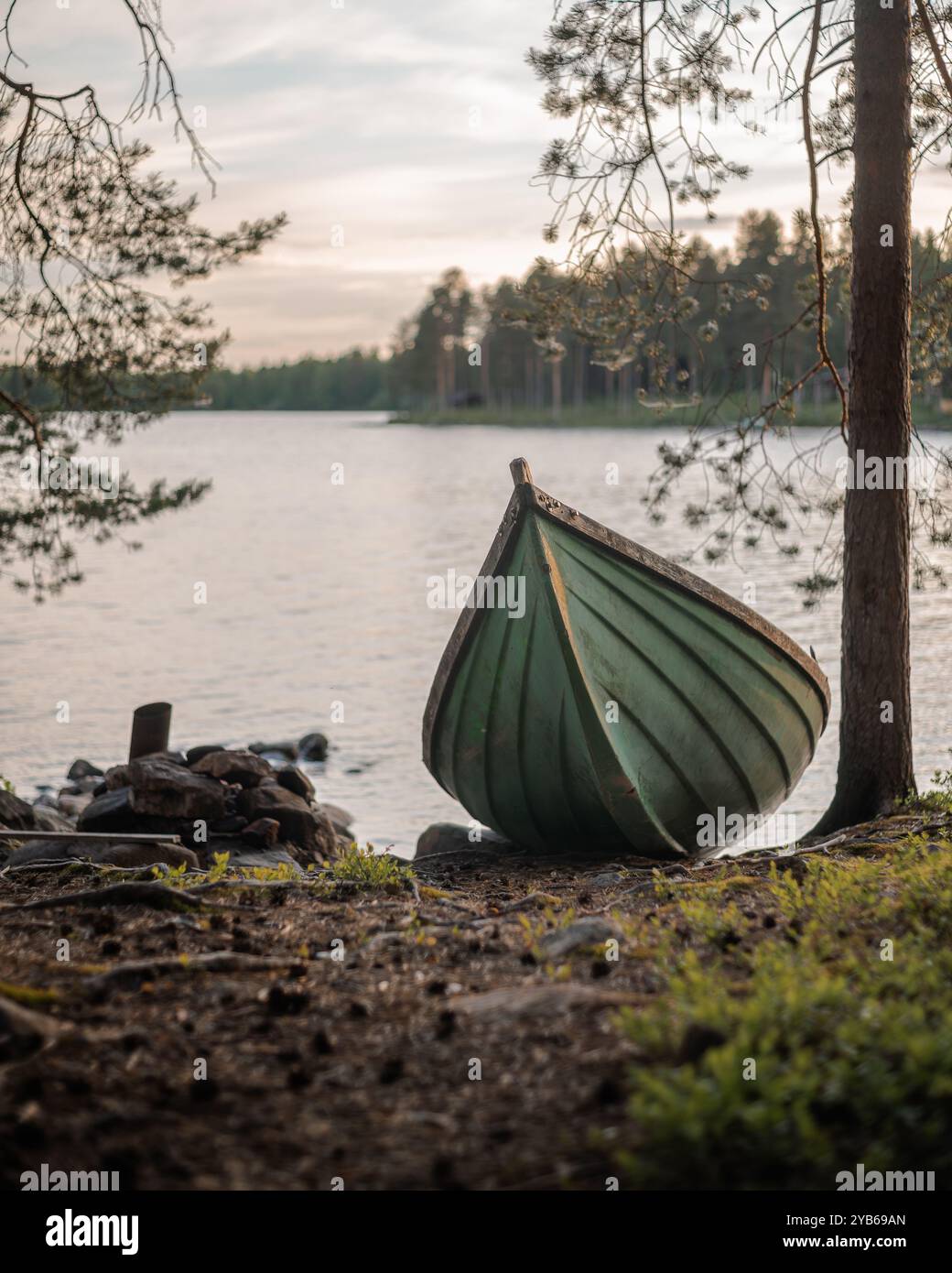 Traditional rowing boat and peaceful scandinavian lake view while sun ...