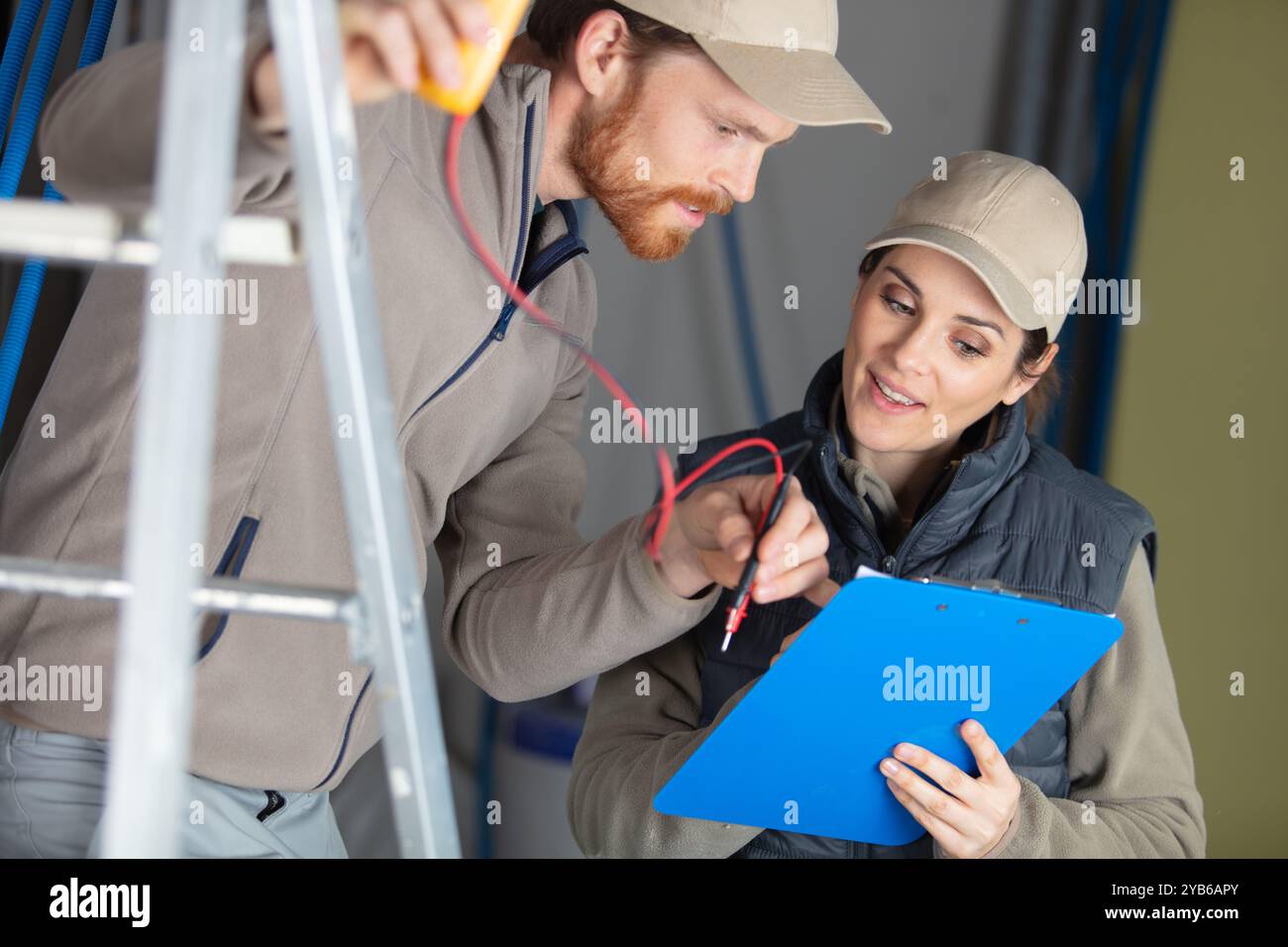 mentor supervising female electrical engineer Stock Photo - Alamy