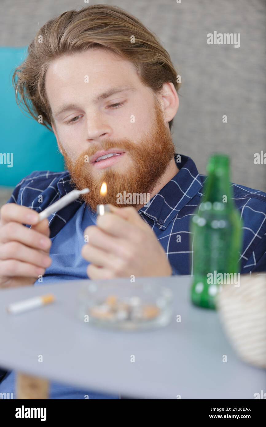 Man drinking beer smoking cigarette hi-res stock photography and images ...