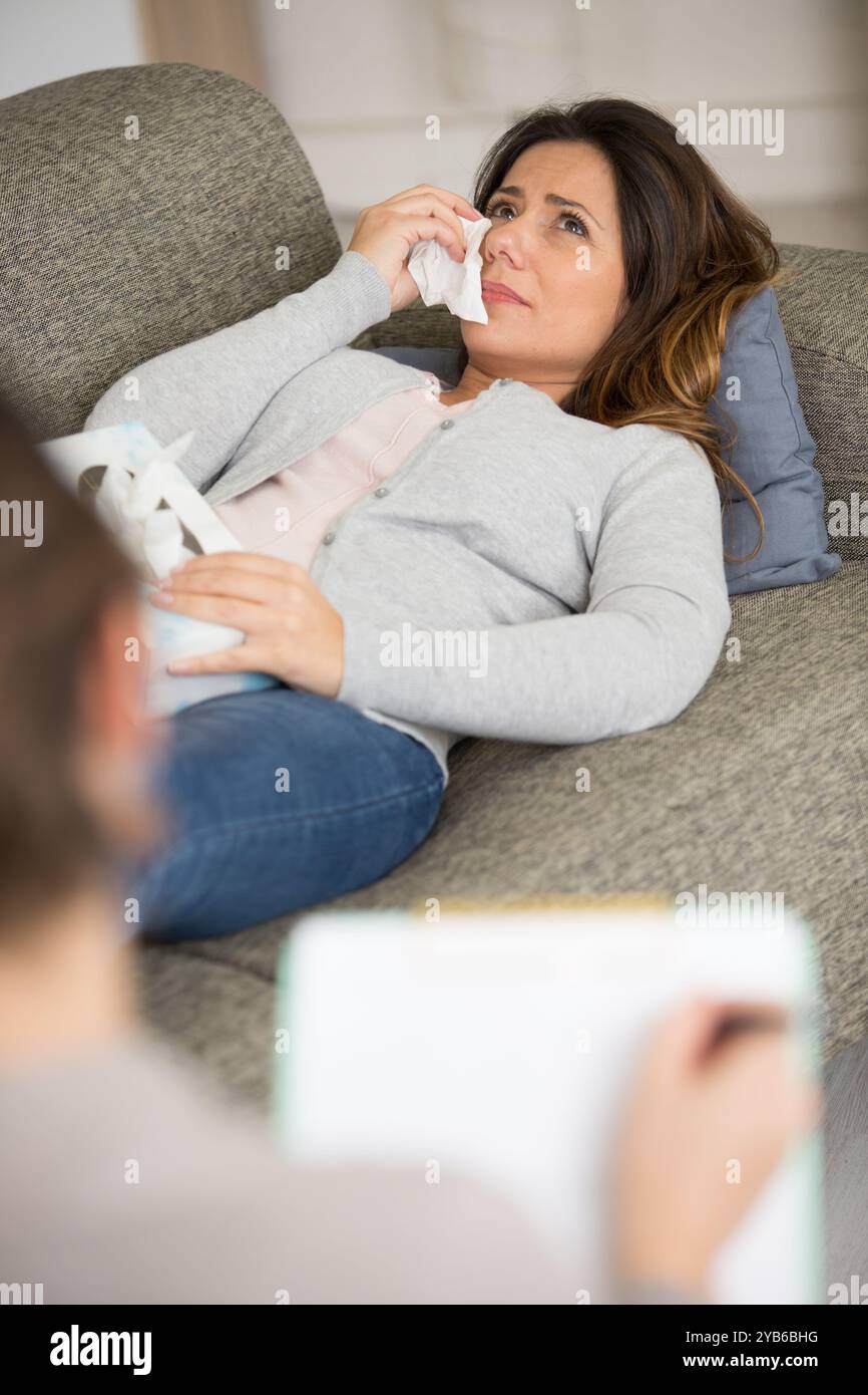 woman lying on sofa and crying during the psychotherapy session Stock ...
