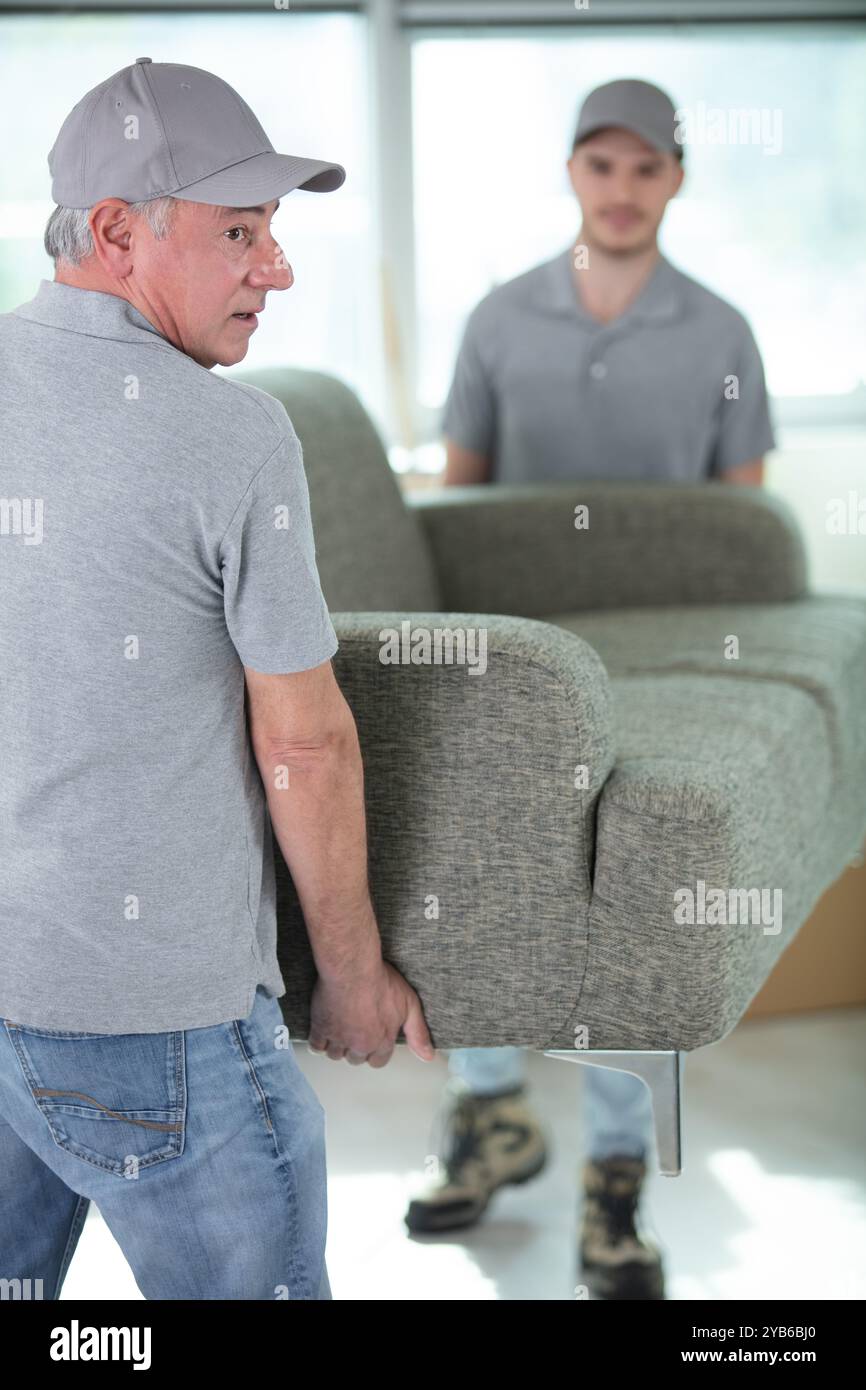 Two men carry heavy hi-res stock photography and images - Alamy