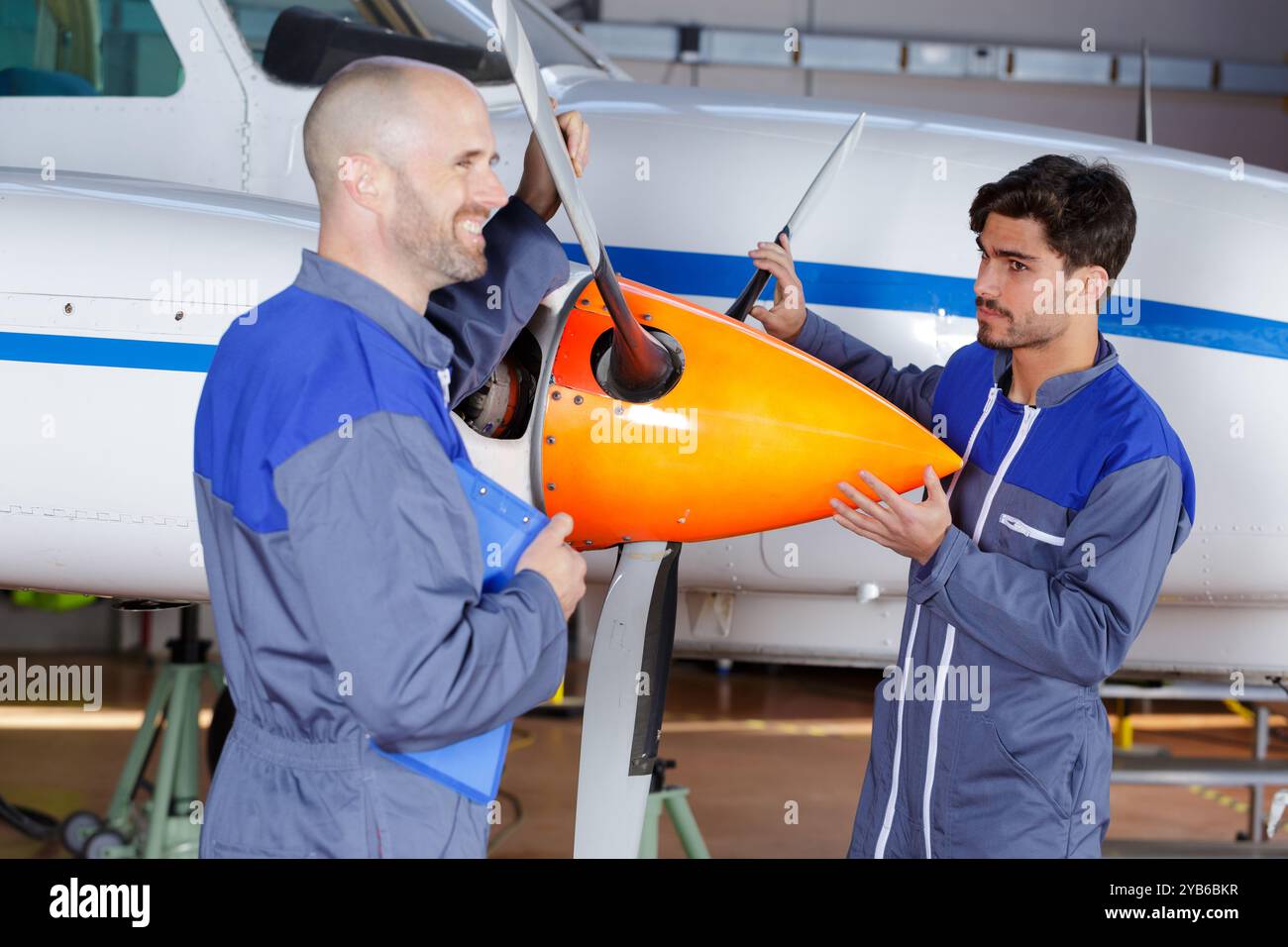 mechanic fixing a propeller aircraft Stock Photo - Alamy