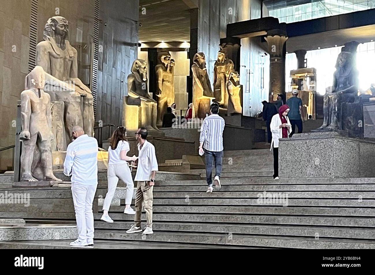 Visitors admire ancient Egyptian artifacts at the Grand Egyptian Museum ...