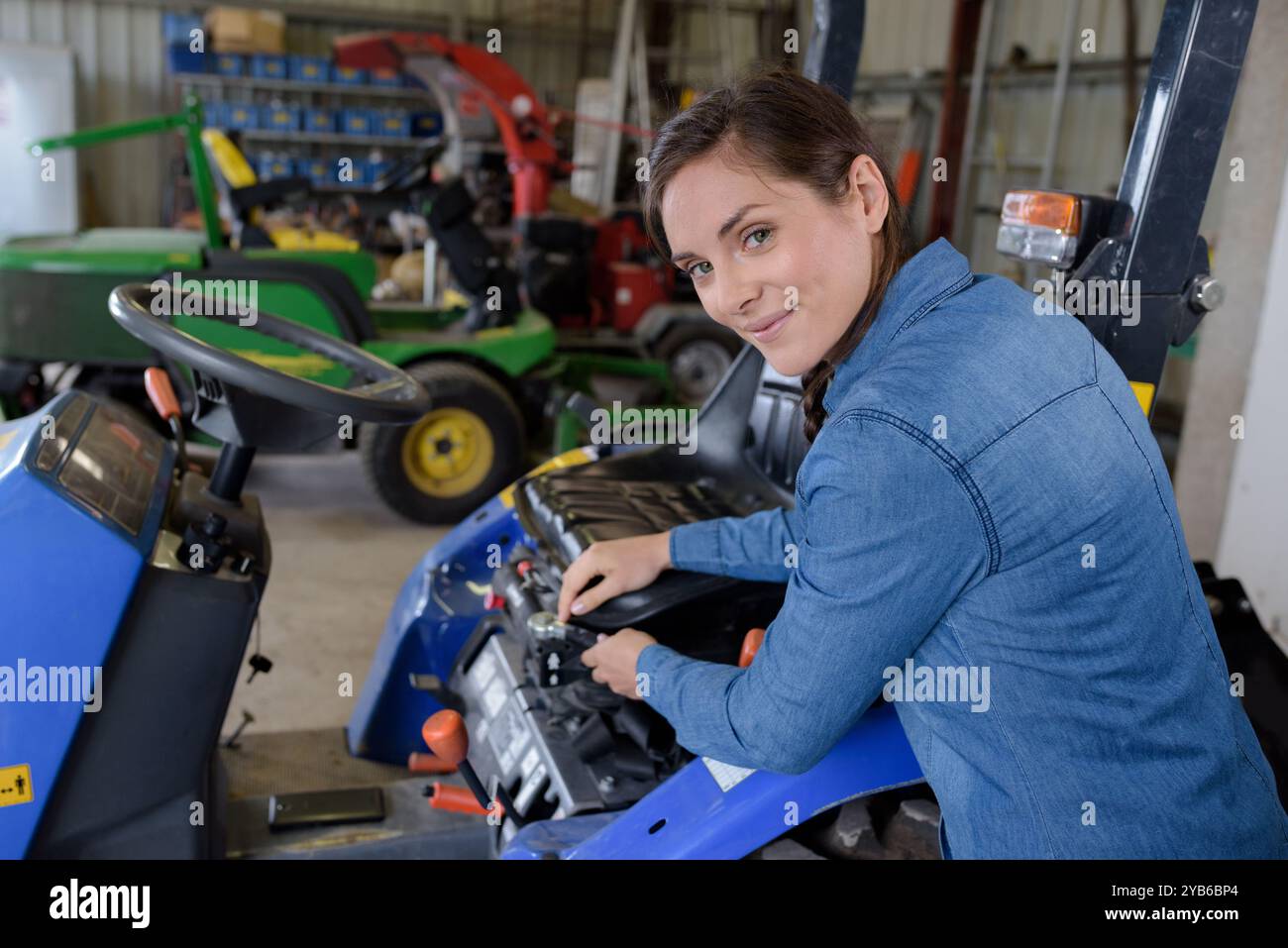 female mechanic carrying out maintenance on professional mower Stock ...