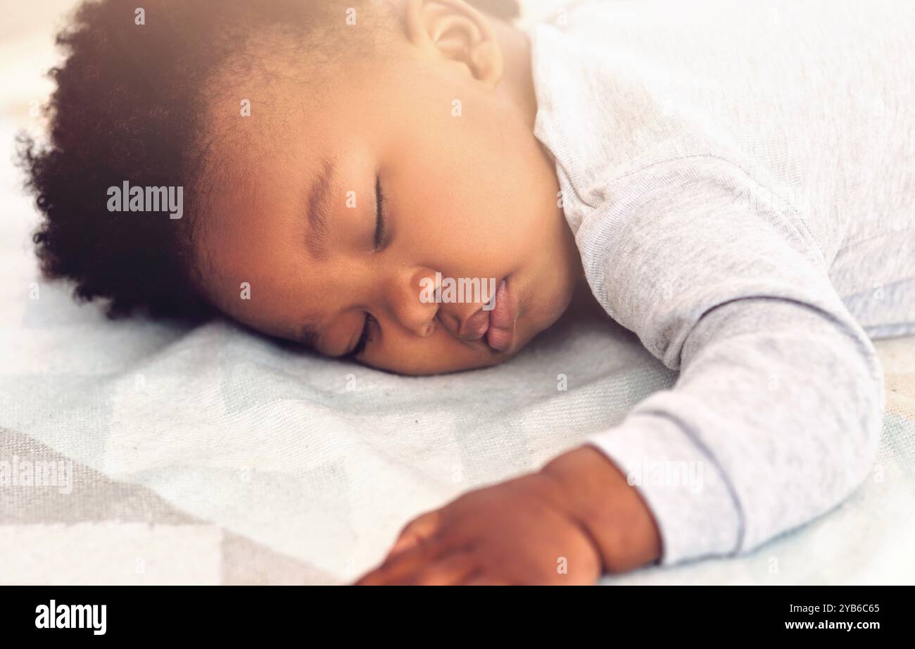 Baby, african and boy sleeping on bed for rest, health and peace for ...