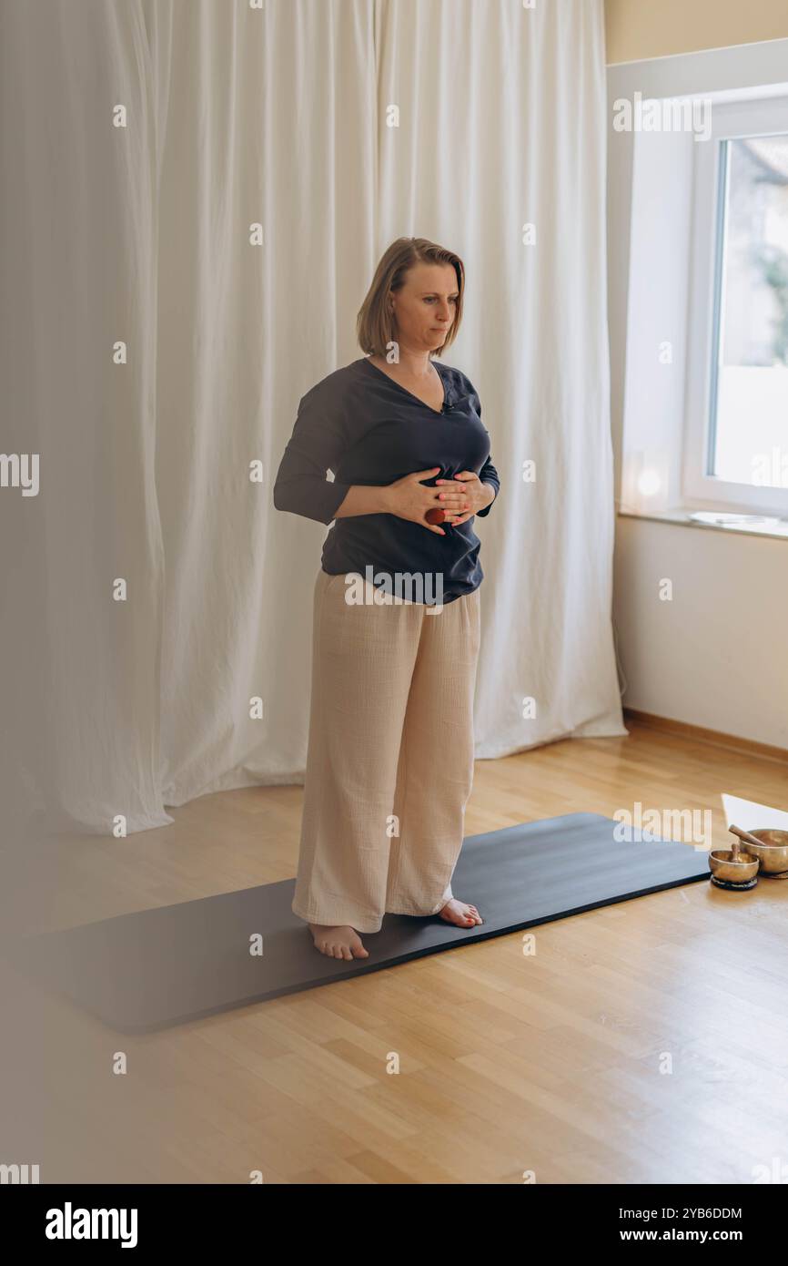 A woman places her hands on her stomach, performing external techniques ...