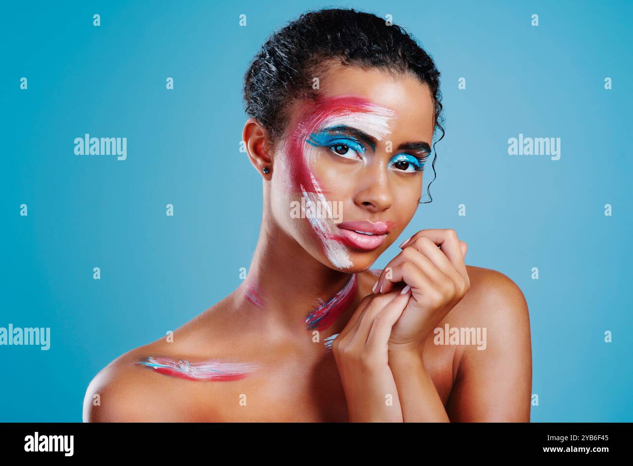 Studio, portrait and woman with face paint, color and creative for ...