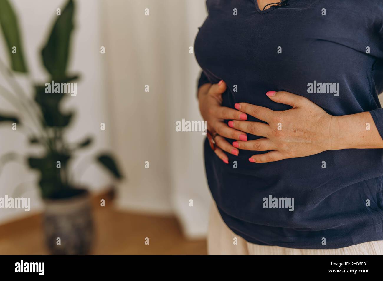 A woman places her hands on her stomach, performing external techniques ...