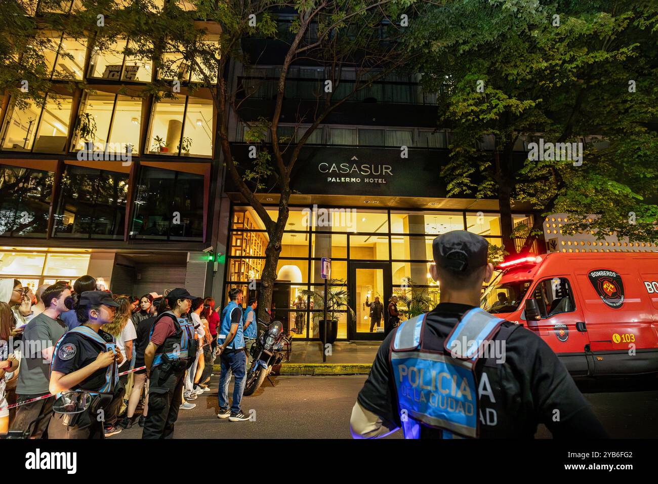 A large group of fans gathers at the doors of the hotel where the ...