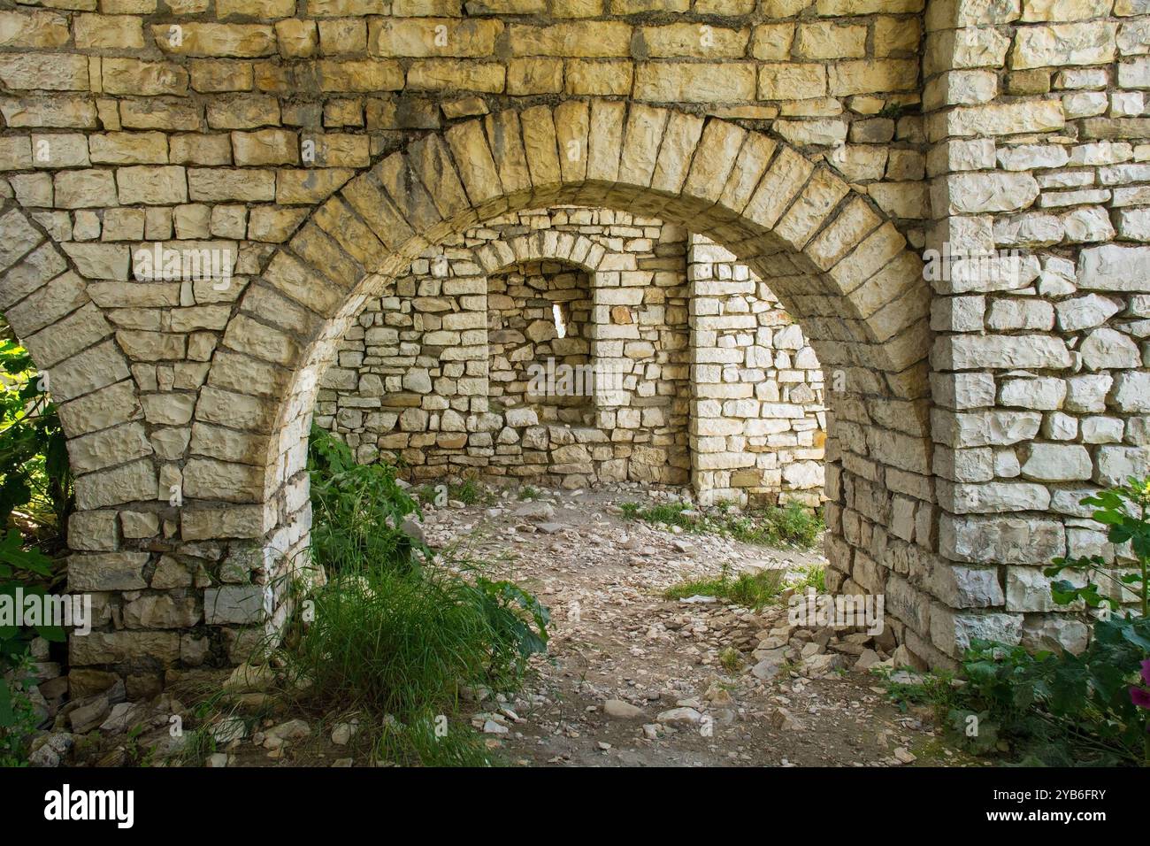 Round-arched openings in a ruin in 13th century Citadel in Berat Castle ...
