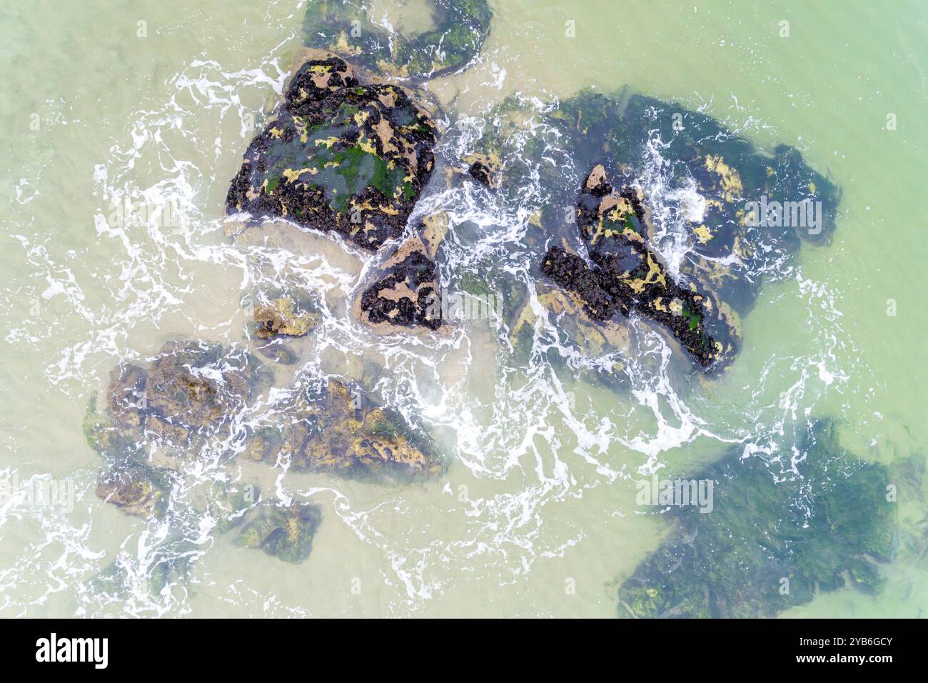 rocks on the shore of a beach, aerial top view with drone. Beach ...