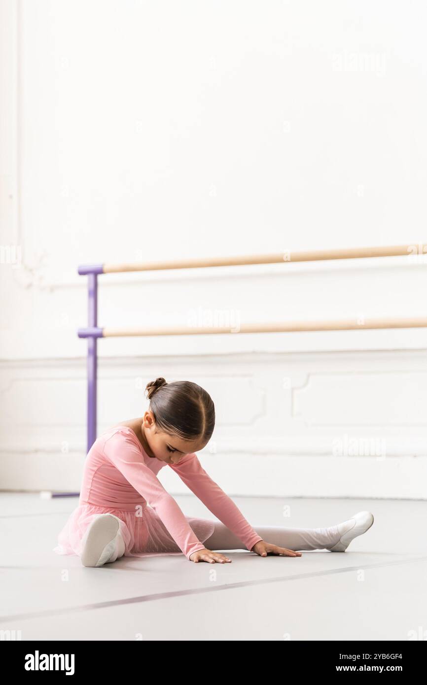 Child practicing ballet choreography on studio floor training ...