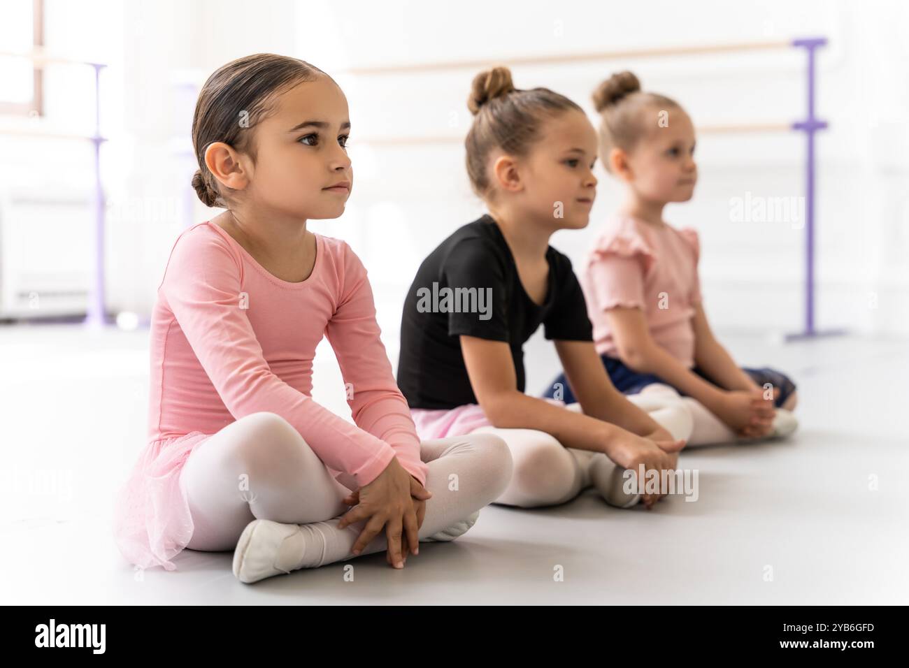 Kids ballet dancers sitting on floor together Stock Photo - Alamy