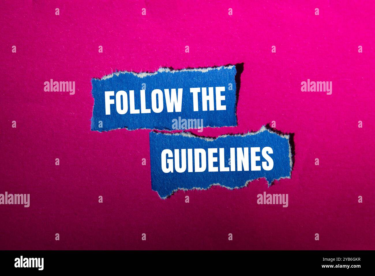 Follow the guidelines message written on ripped torn blue paper pieces ...