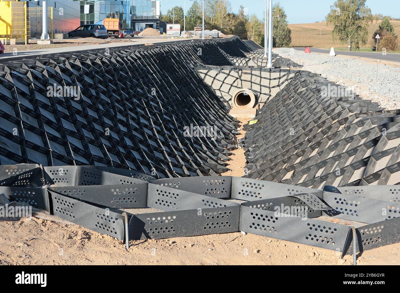 Landscaping of slope at construction site. Plastic geogrid for ...