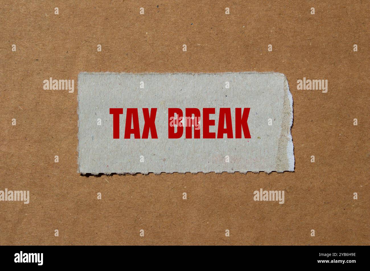 Tax break message written on ripped torn paper piece with cardboard ...