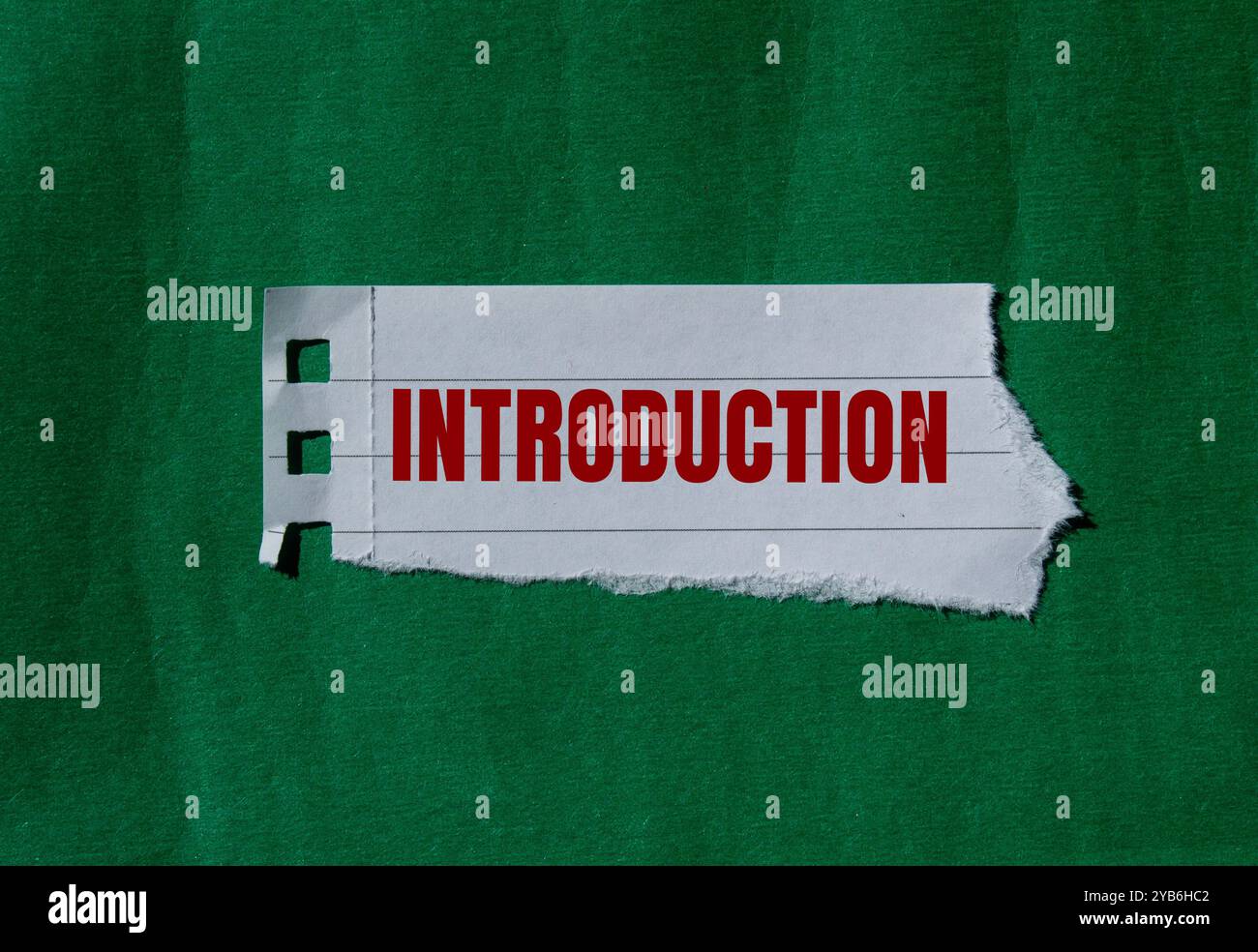 Introduction message written on ripped torn paper with green background ...