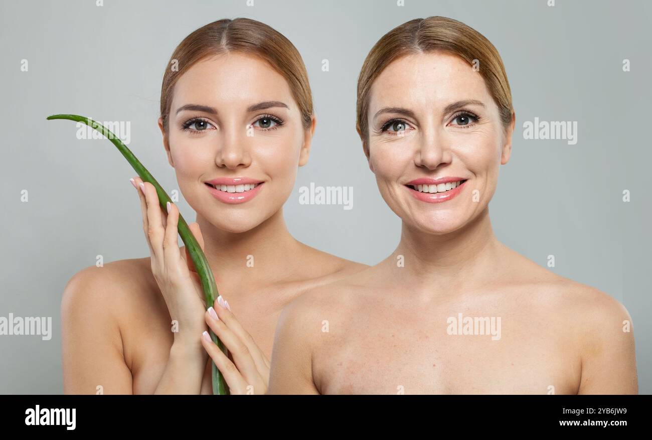 Two smiling happy female models holding aloe vera leaf on white ...