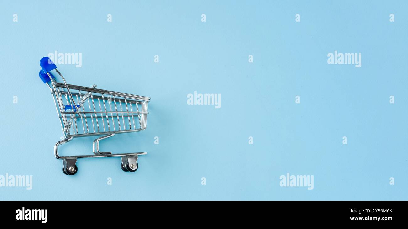 Shopping trolley on blue background hi-res stock photography and images ...