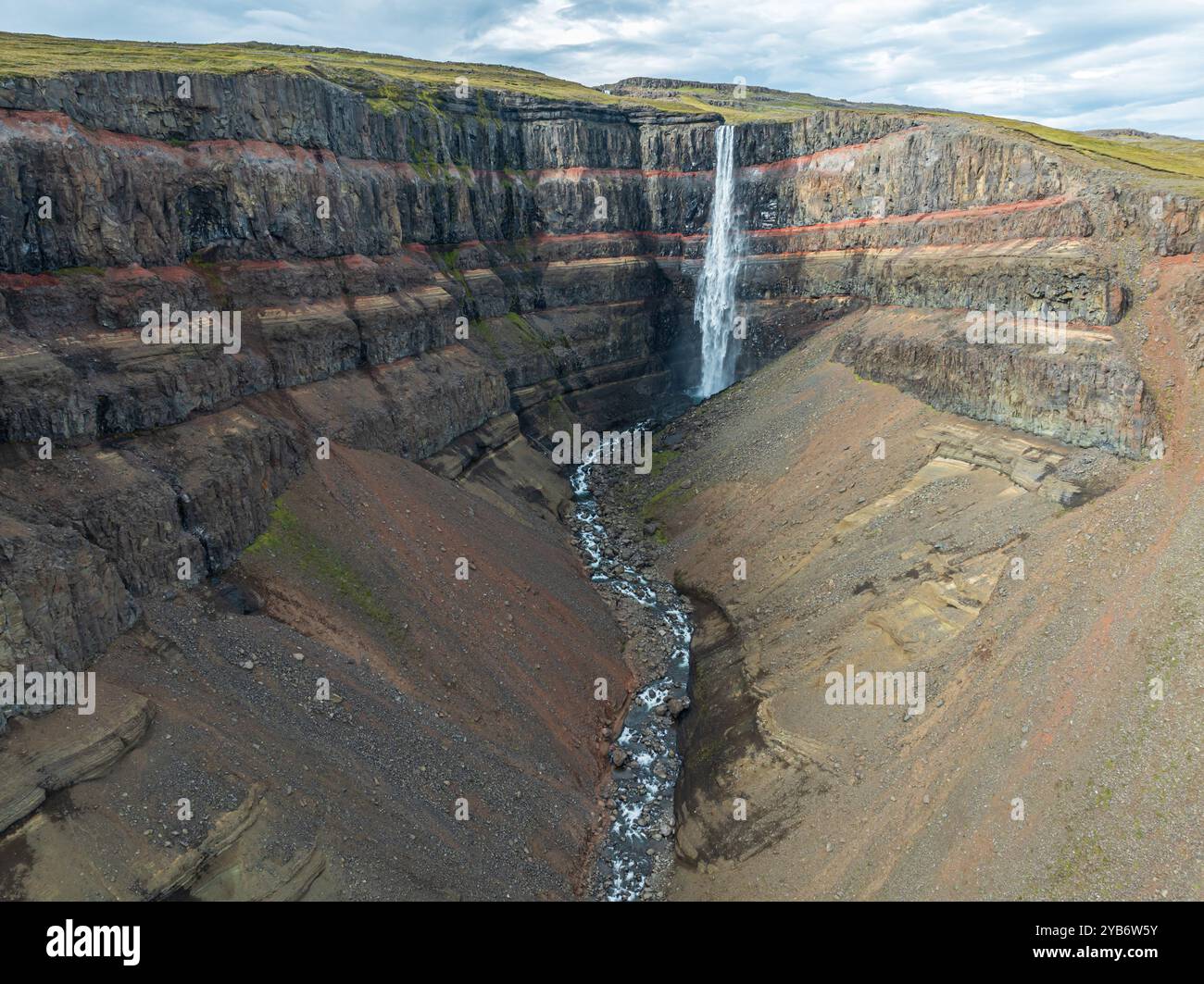 Waterfall Hengifoss, basaltic layers interwoven with red sedimentary ...