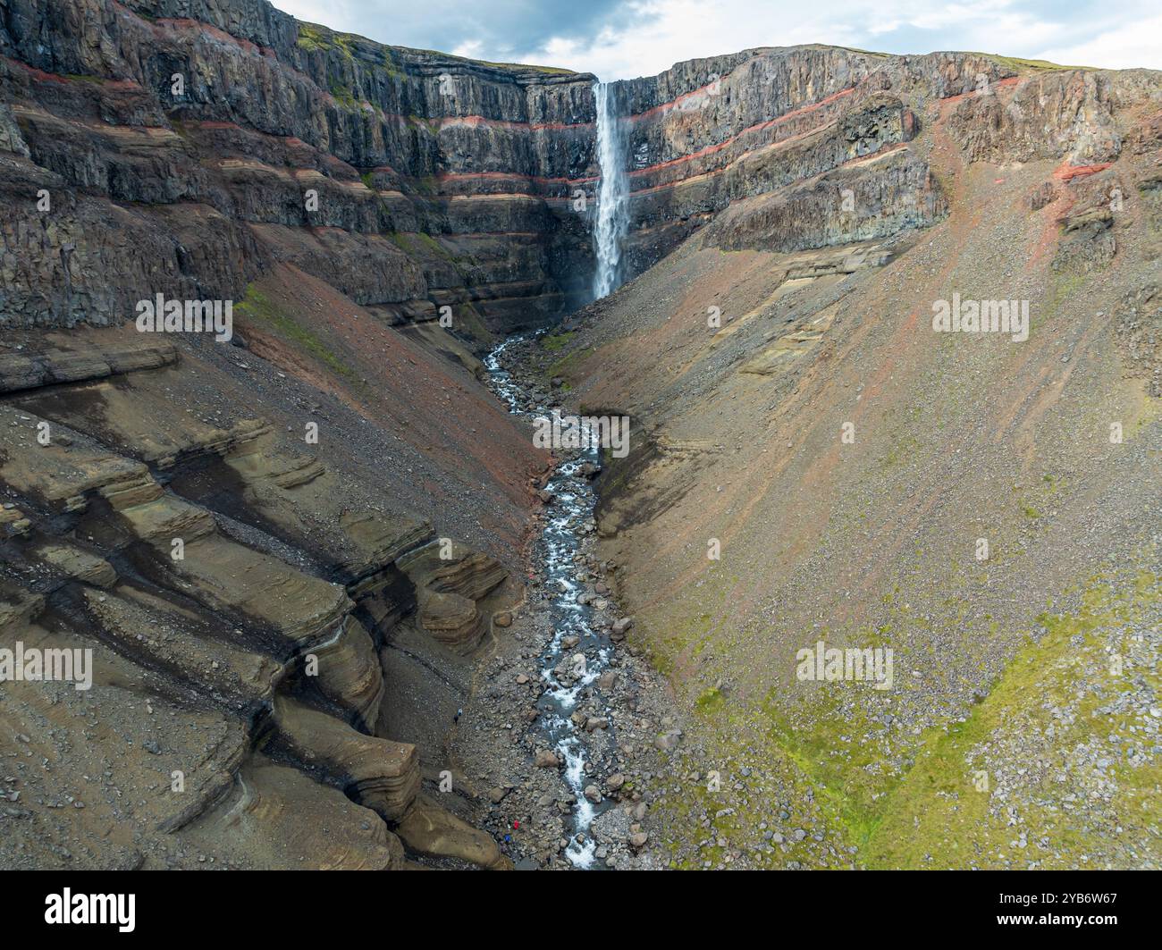 Waterfall Hengifoss, basaltic layers interwoven with red sedimentary ...