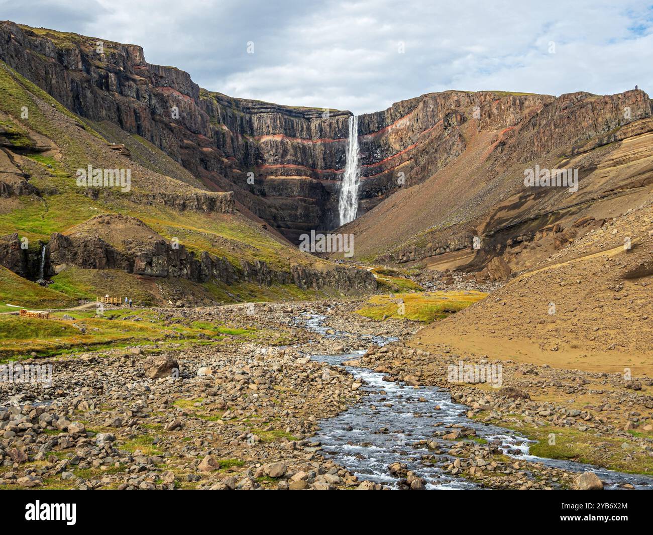 Waterfall Hengifoss, basaltic layers interwoven with red sedimentary ...