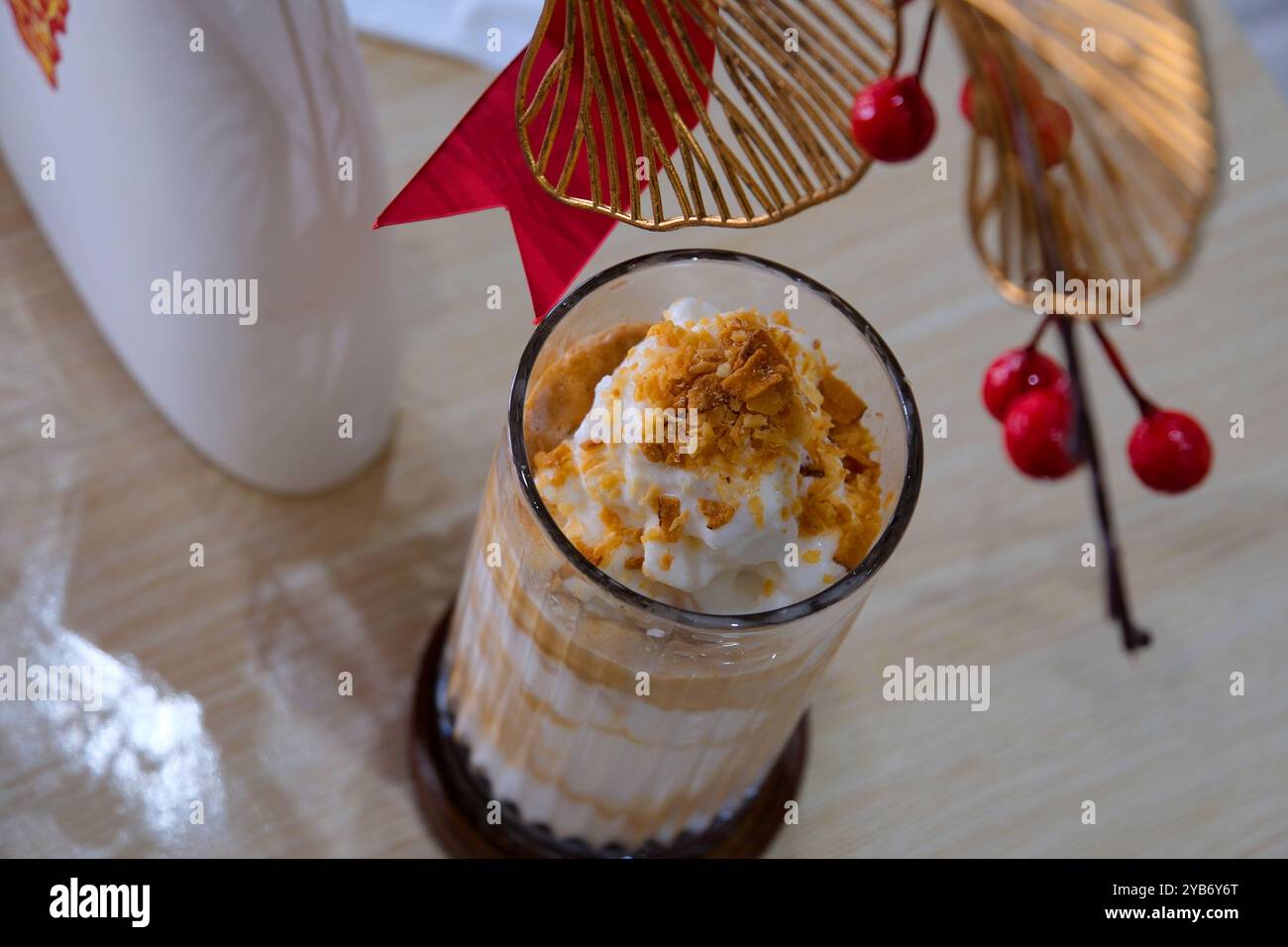 Chocolate milk pouring into a glass, splashing as it flows over ...