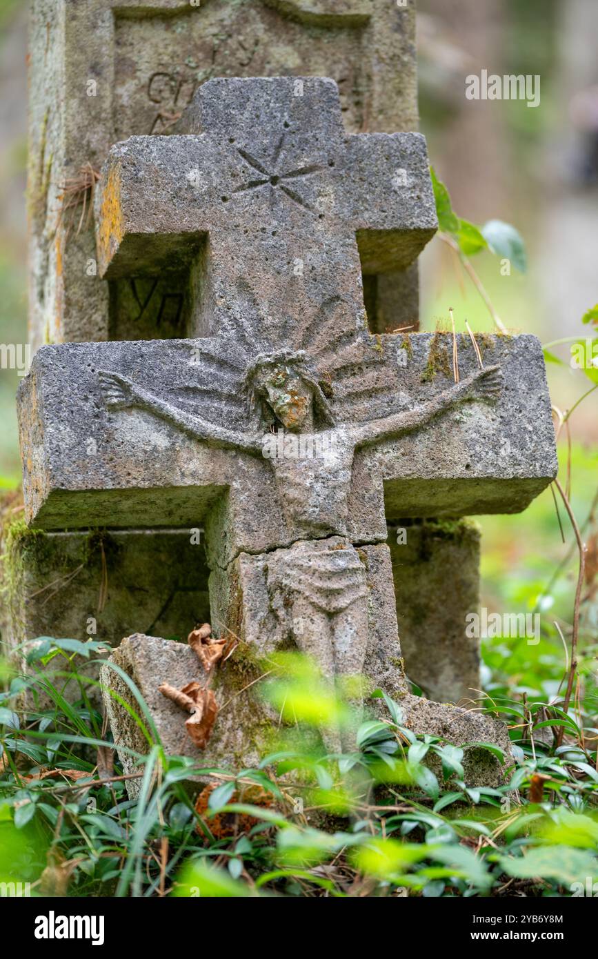 old white crosses and tombstones in a rundown forgotten cemetery in ...