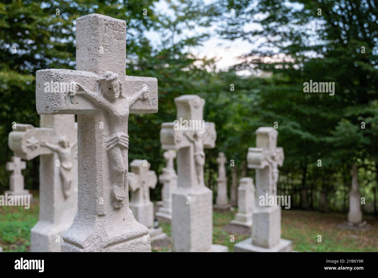 old white crosses and tombstones in a rundown forgotten cemetery in ...