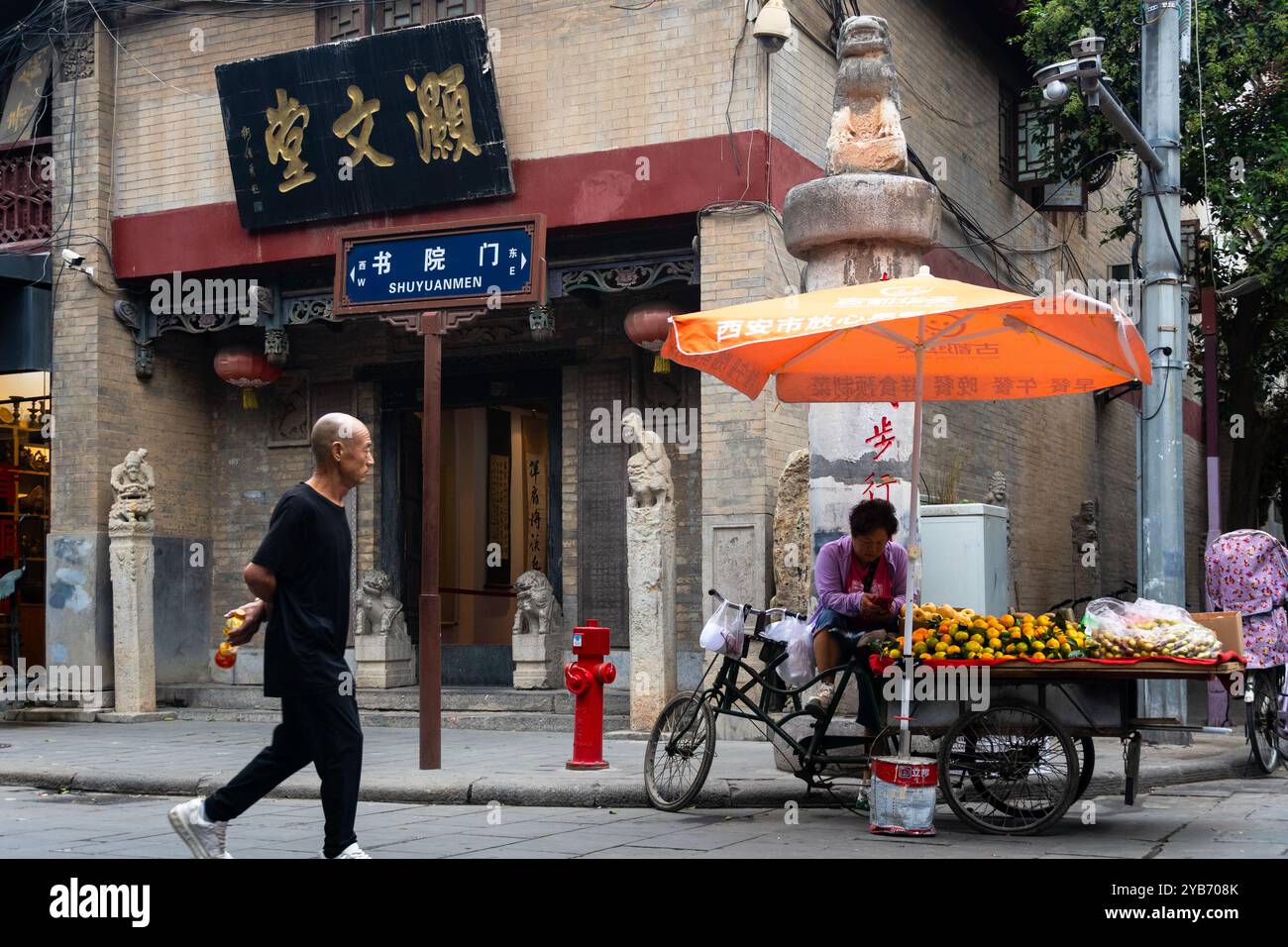 Xi'an, China - September 21 2024: Local woman sell fresh fruits in the ...