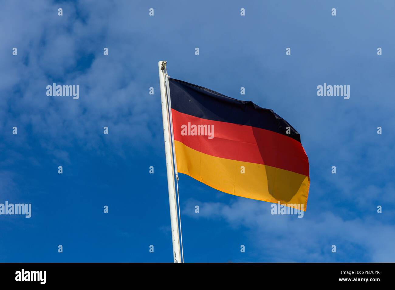 The German flag, featuring black, red, and gold stripes, flutters ...
