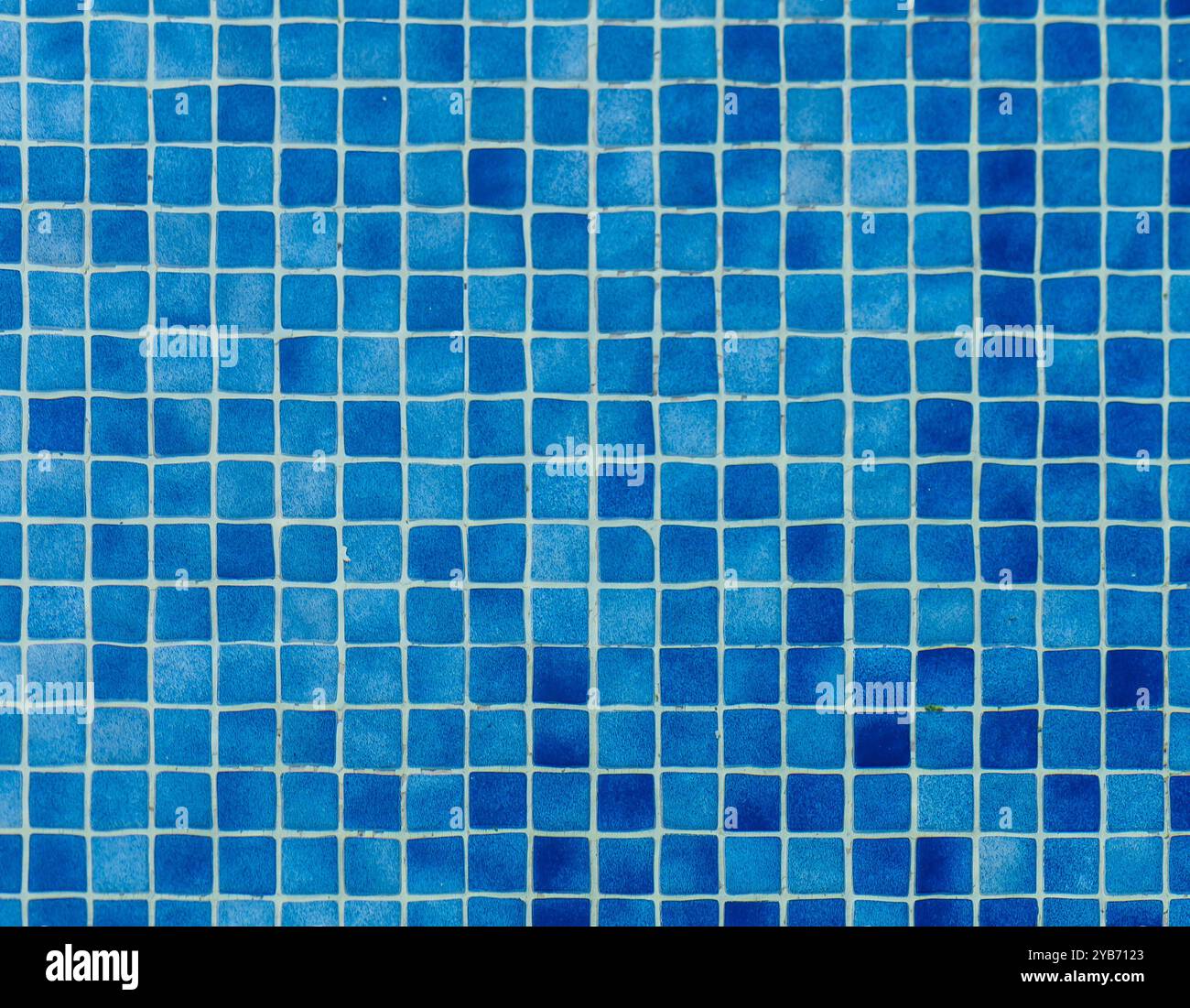 A vibrant arrangement of blue mosaic tiles forms a striking pattern ...