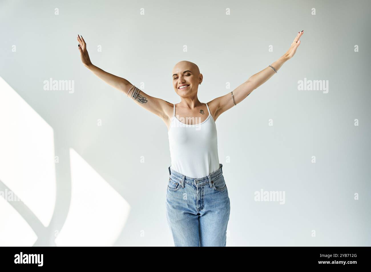 A confident young woman shows her radiant smile while celebrating her ...