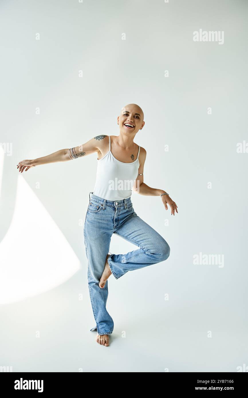 A young bald woman exudes confidence and joy while standing playfully ...